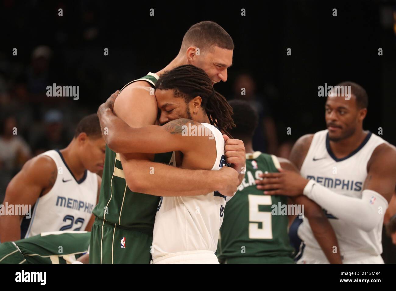 Milwaukee Bucks center Brook Lopez (11) embraces Memphis Grizzlies guard Derrick Rose (23) in ...