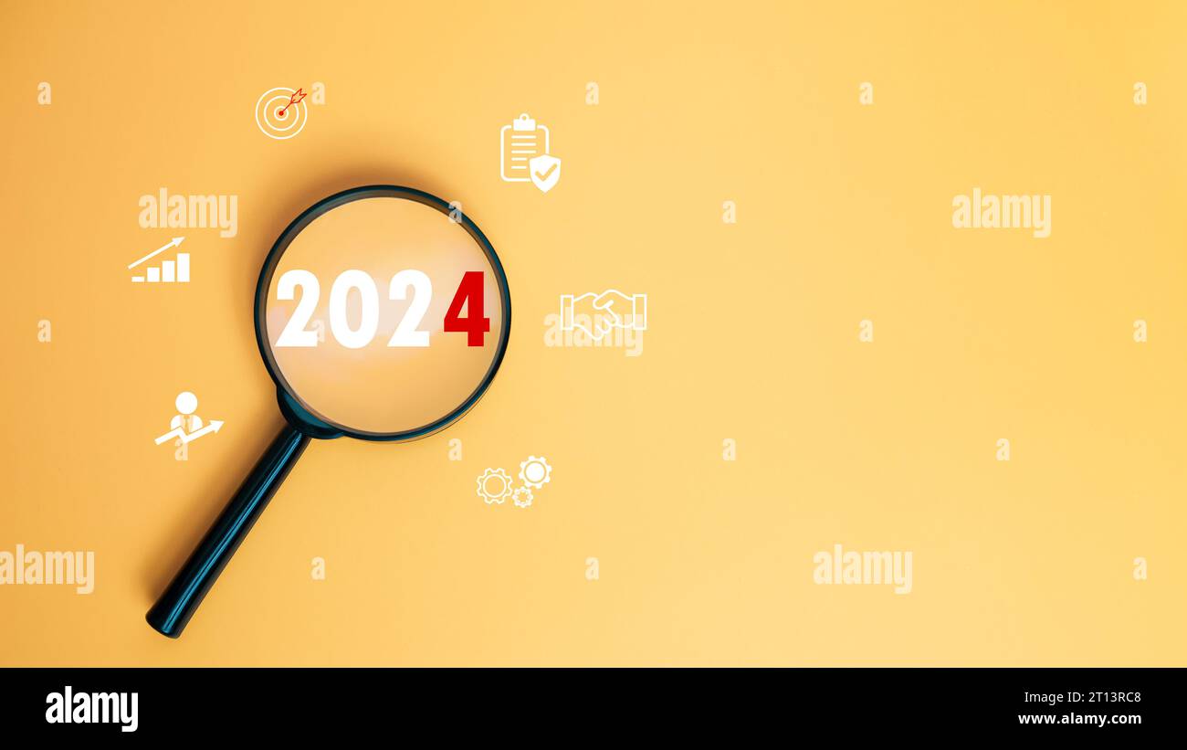 Magnifying glass focused on letter 2024 on yellow background ...