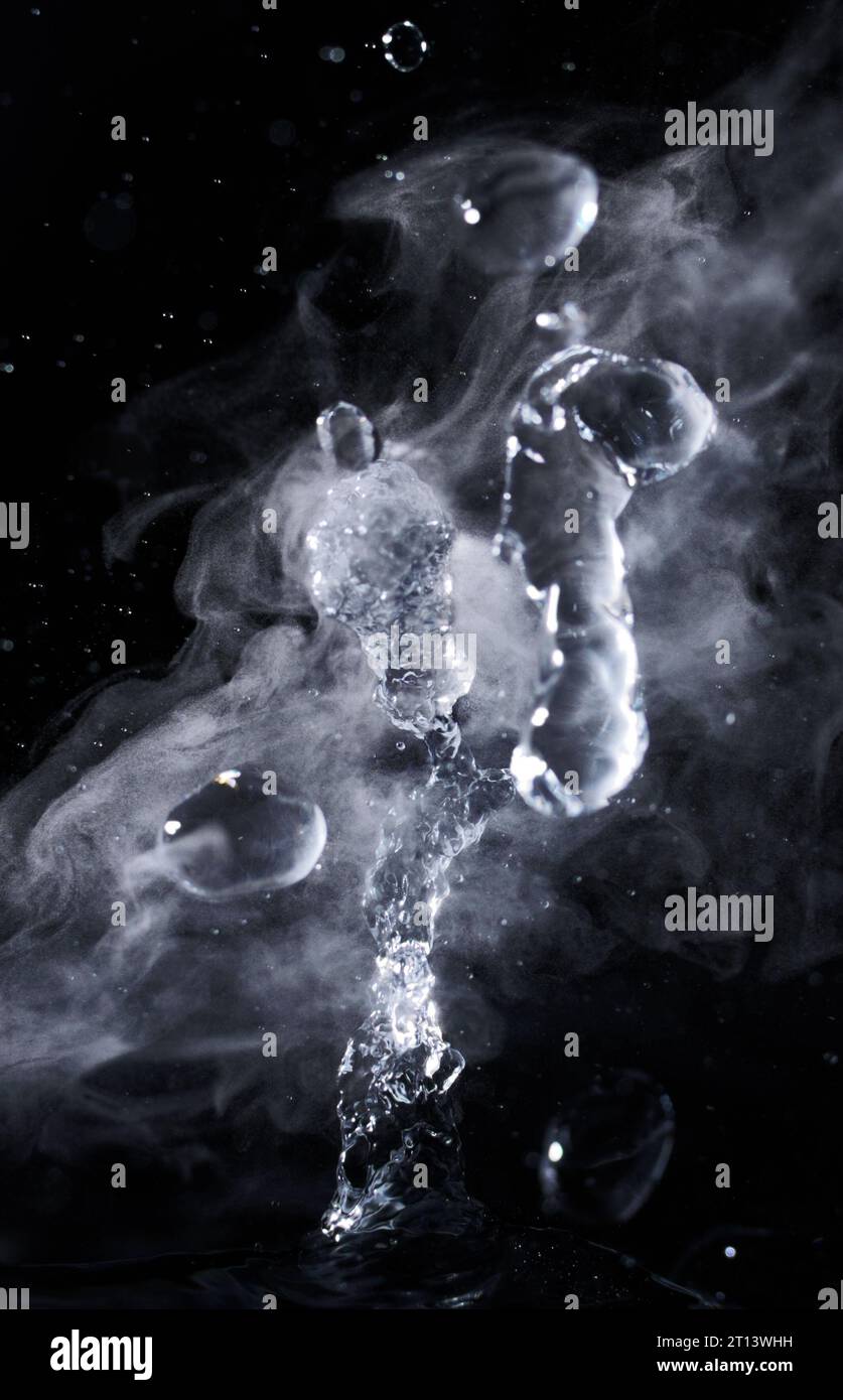 Boiling water splash with steam on black background closeup Stock Photo ...