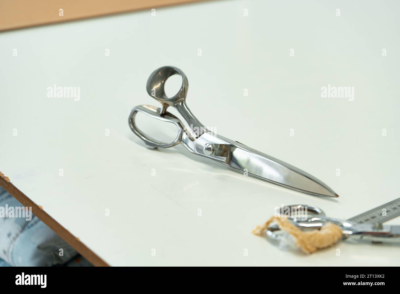 Tailor's work desk with sewing tools close up Stock Photo - Alamy