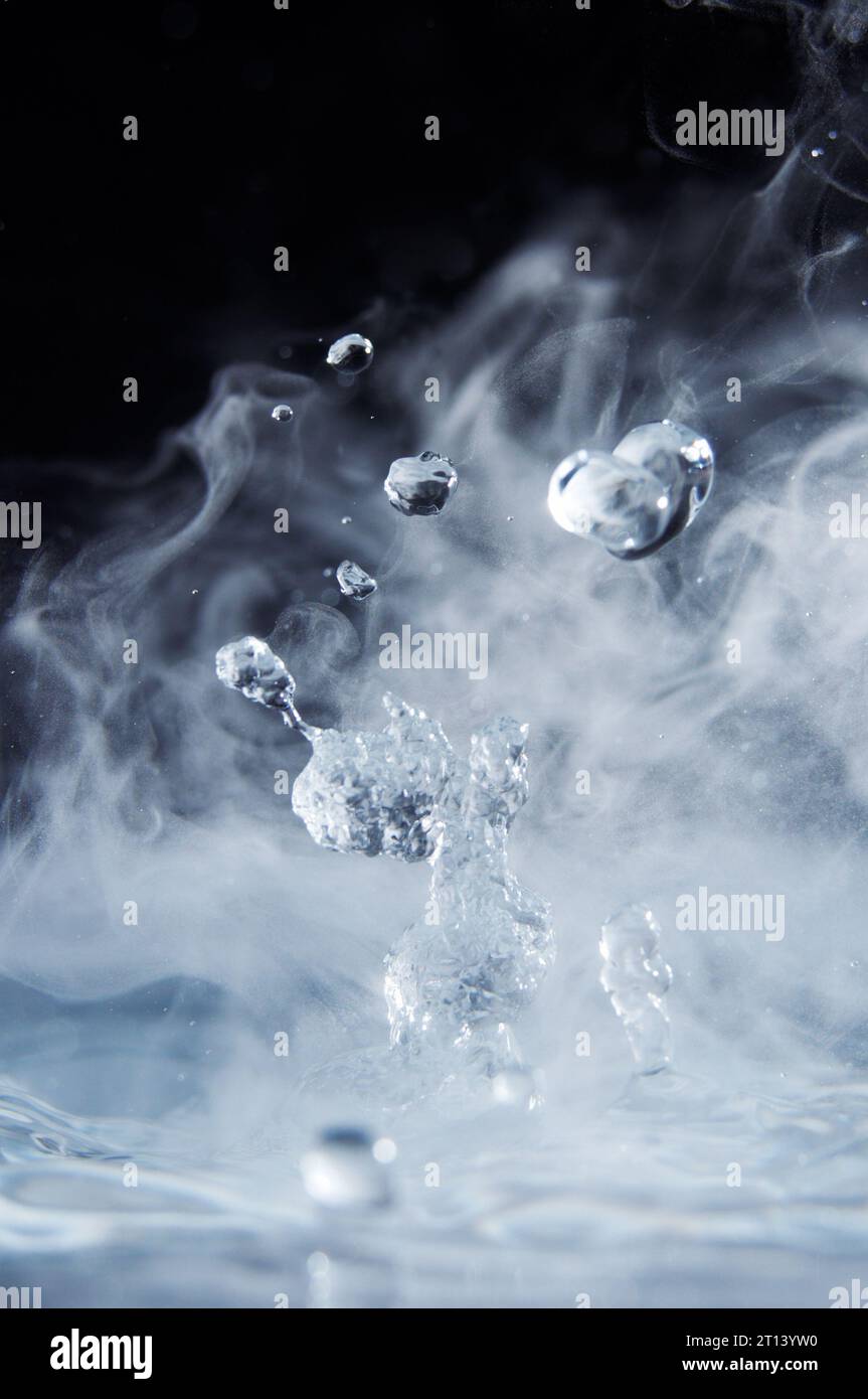 Boiling water splash with steam on black background closeup Stock Photo ...