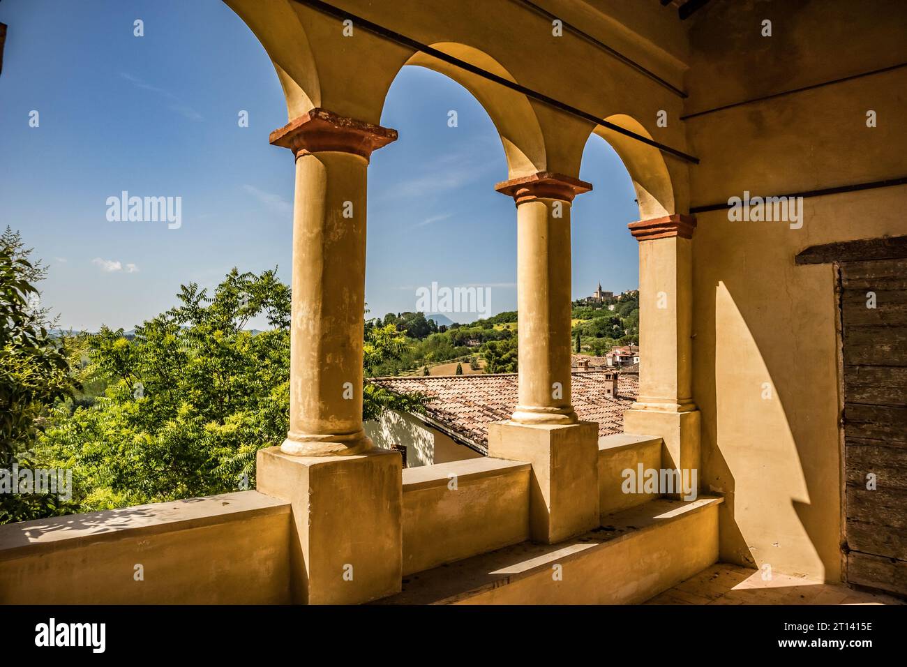 Valley greenery seen through the arches of an old architecture balcony ...