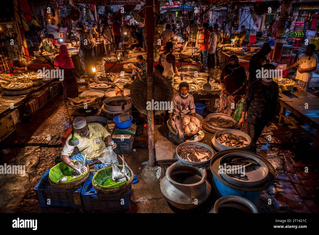 People gathered at a local fish market to buy fish at Barishal city ...