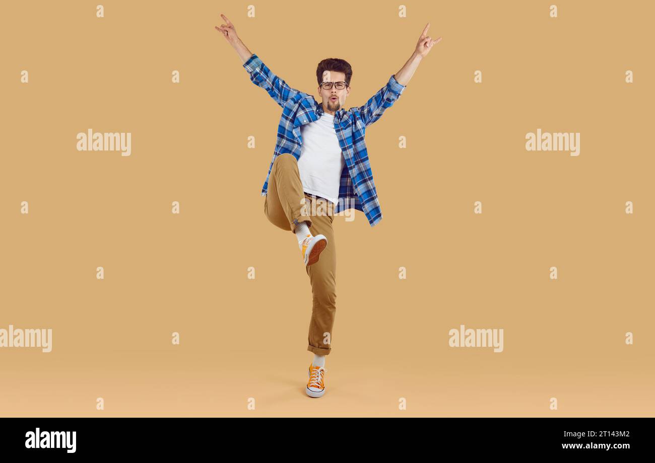 Shot of young man showing rock sign hand gesture Stock Photo - Alamy