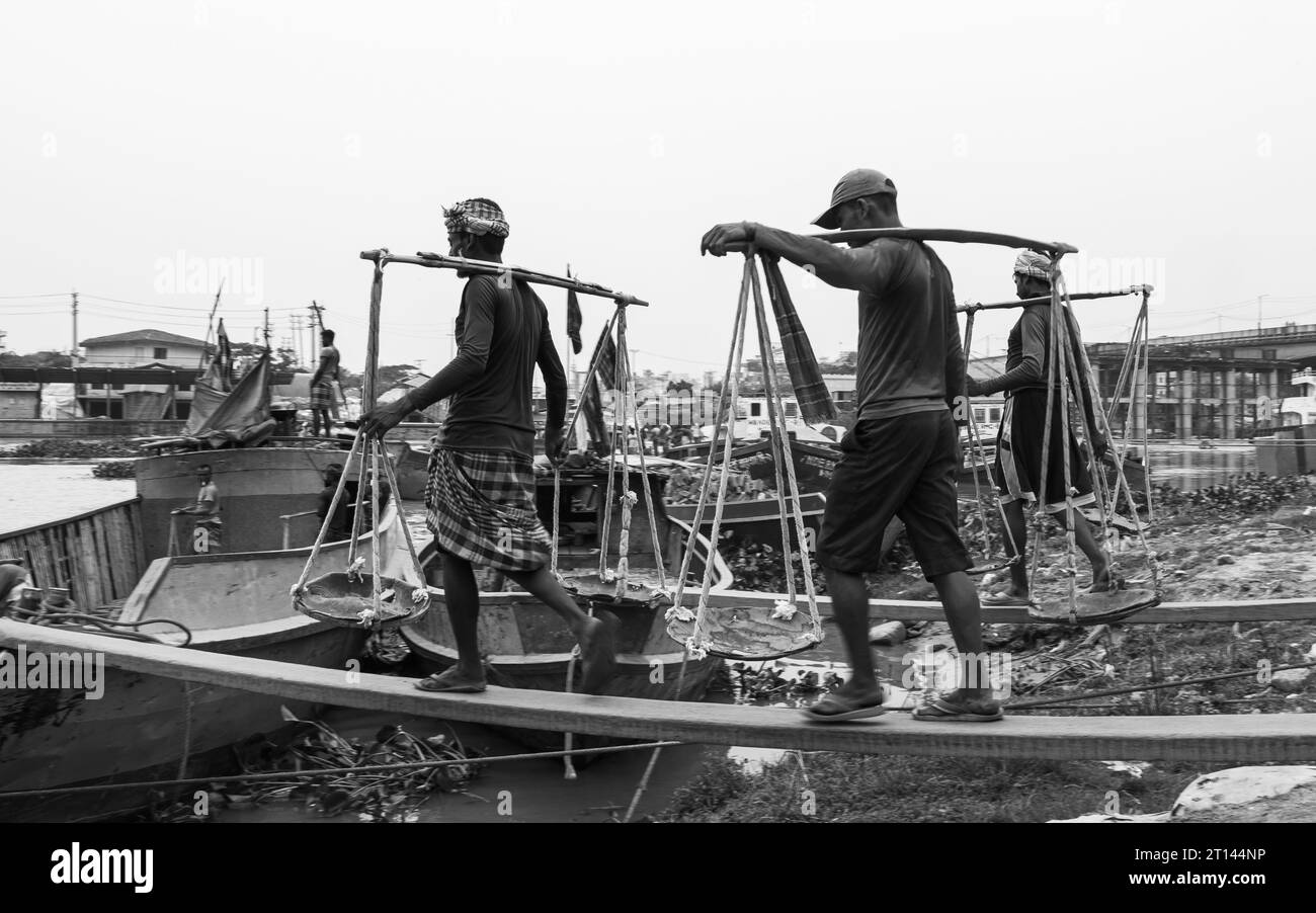 People offloading bricks from the boat, the image captured on May 29 ...