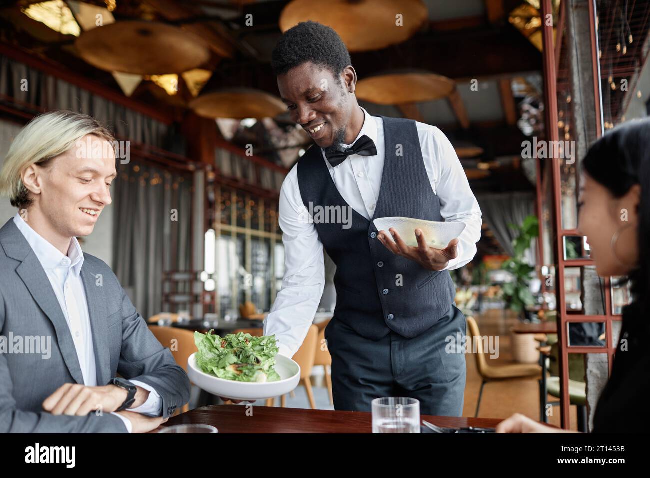 African waiter woman restaurant plate hi-res stock photography and ...