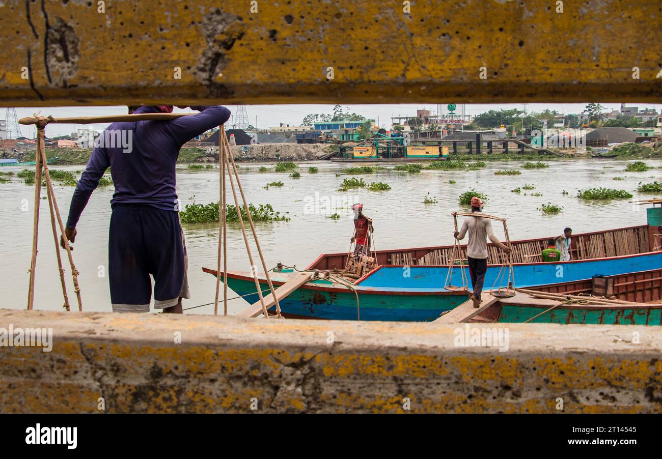 People offloading bricks from the boat, the image captured on May 29 ...