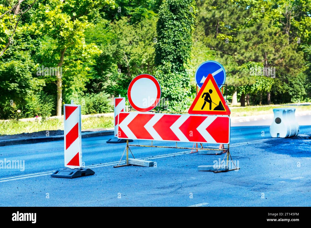 Road signs and the traffic light . Roadworks, road signs in a highway ...