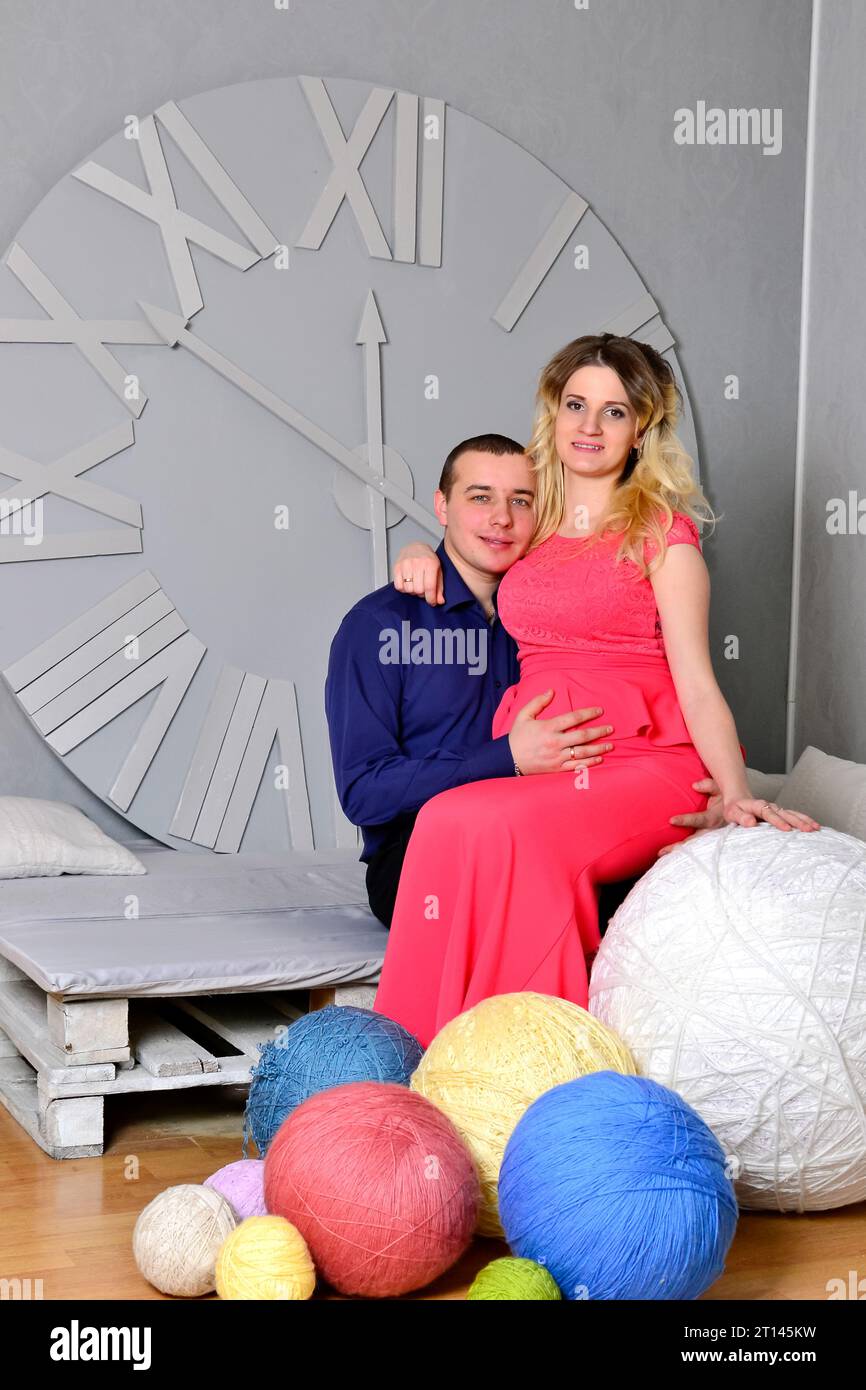 Attractive young couple is celebrating holiday at home. Standing on the ...