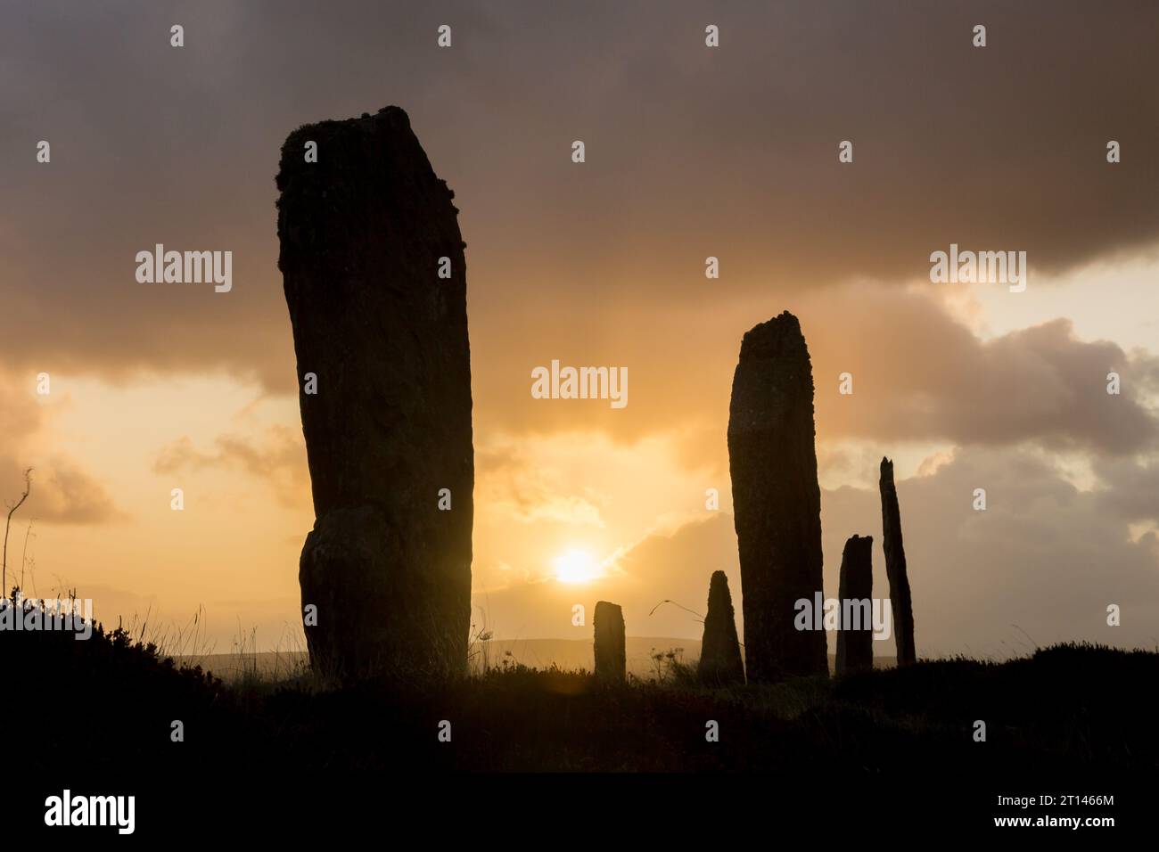 The sun rises behind the neolithic standing stones of the Ring of ...