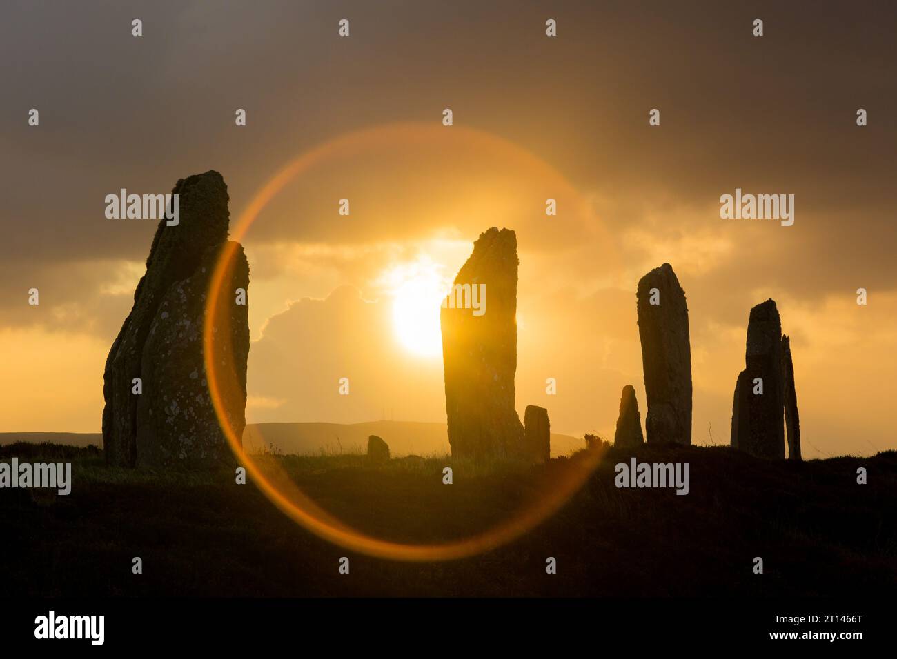 The sun rises behind the neolithic standing stones of the Ring of ...
