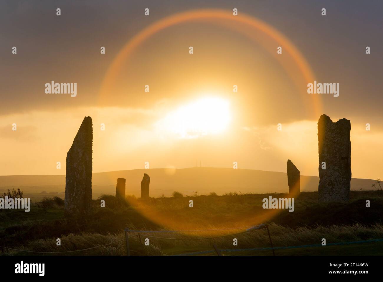 The sun rises behind the neolithic standing stones of the Ring of ...