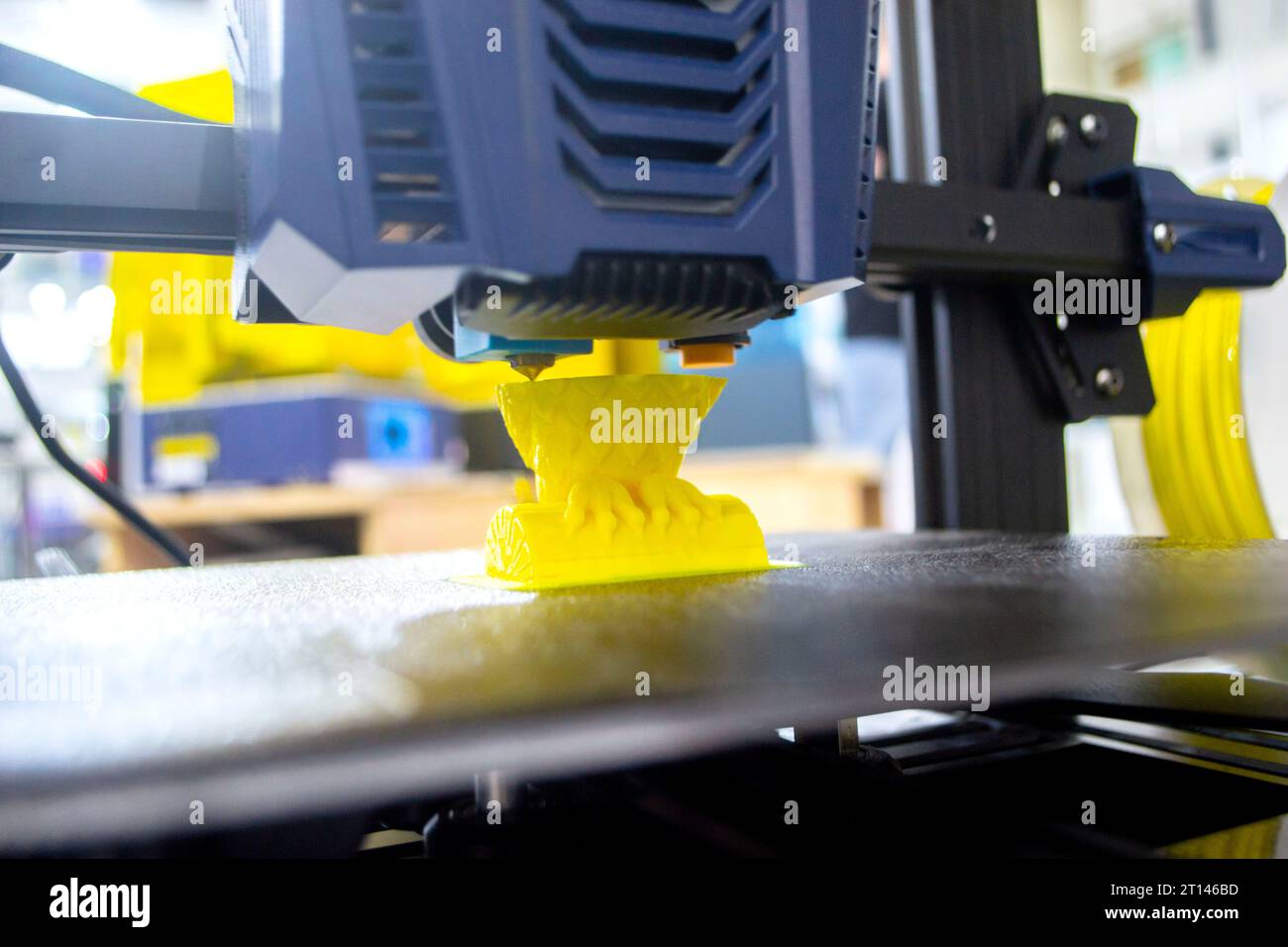 3D printer printing prototype from molten plastic. Process of creating ...