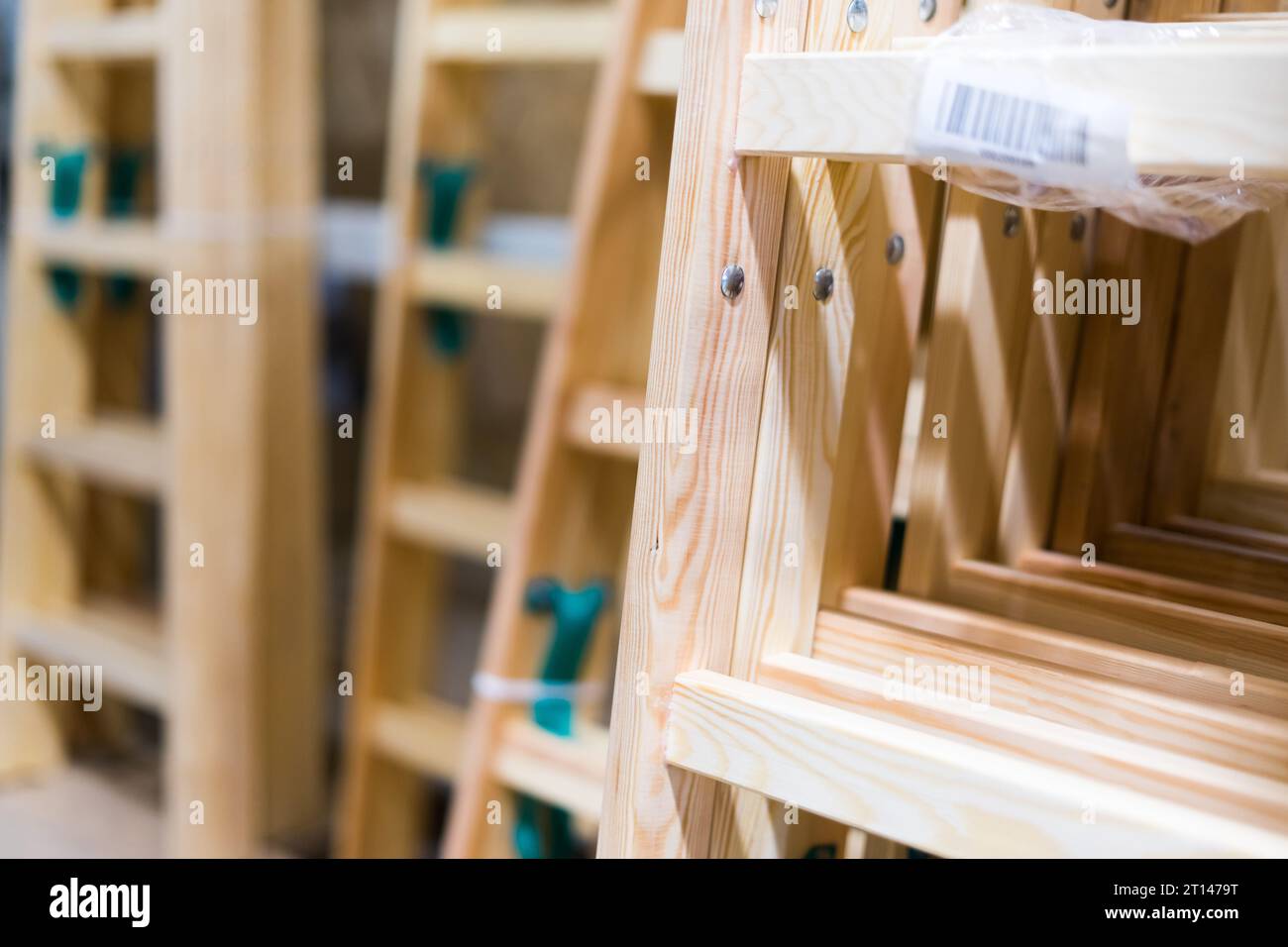 Many Wooden ladders. Stack of wooden stairs in a store Stock Photo - Alamy