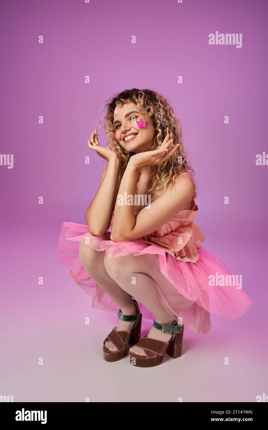 lovely jolly woman in pink costume of tooth fairy with face stickers ...