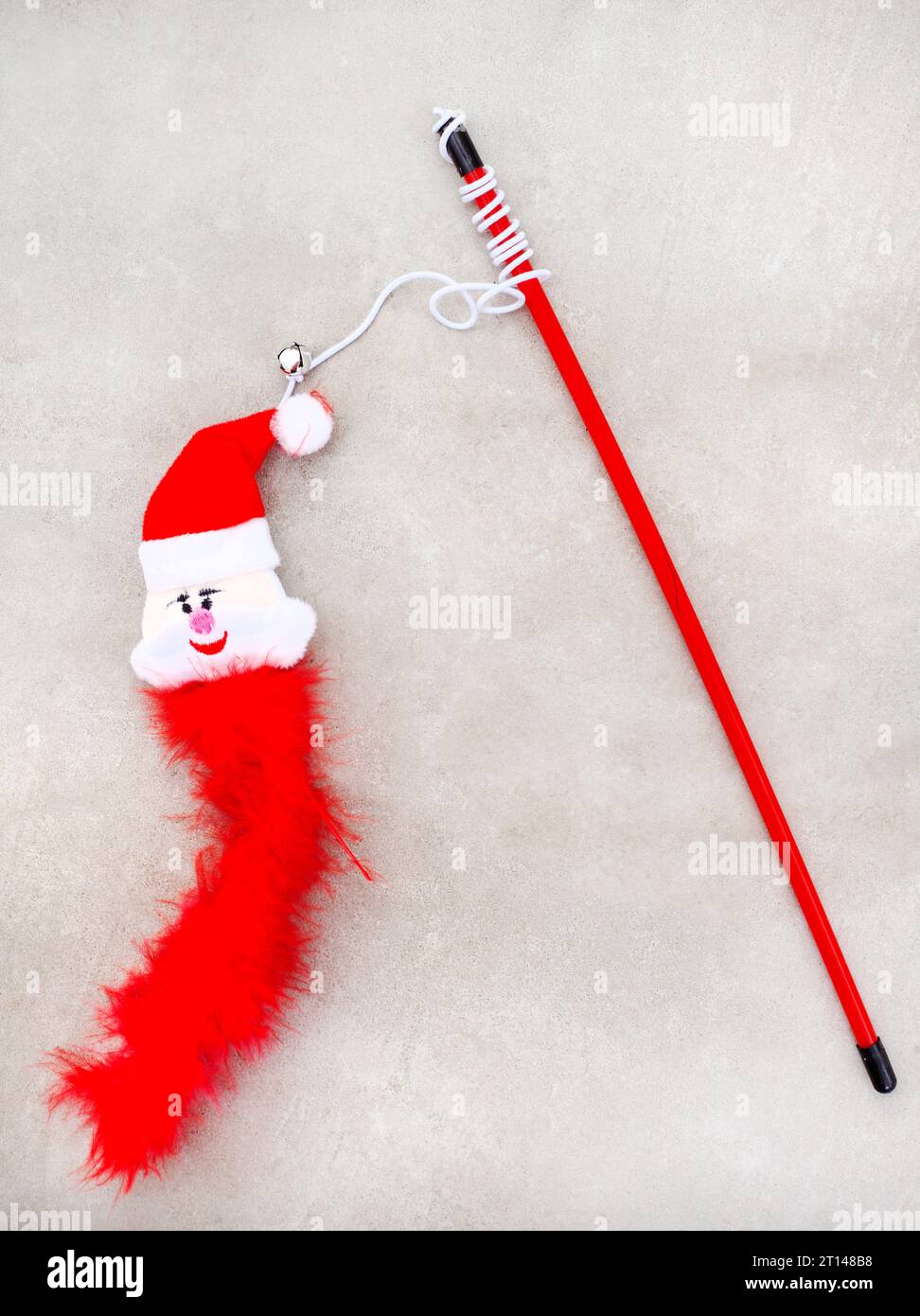 Cat toy Christmas themed. Feather and Santa on stick Stock Photo - Alamy