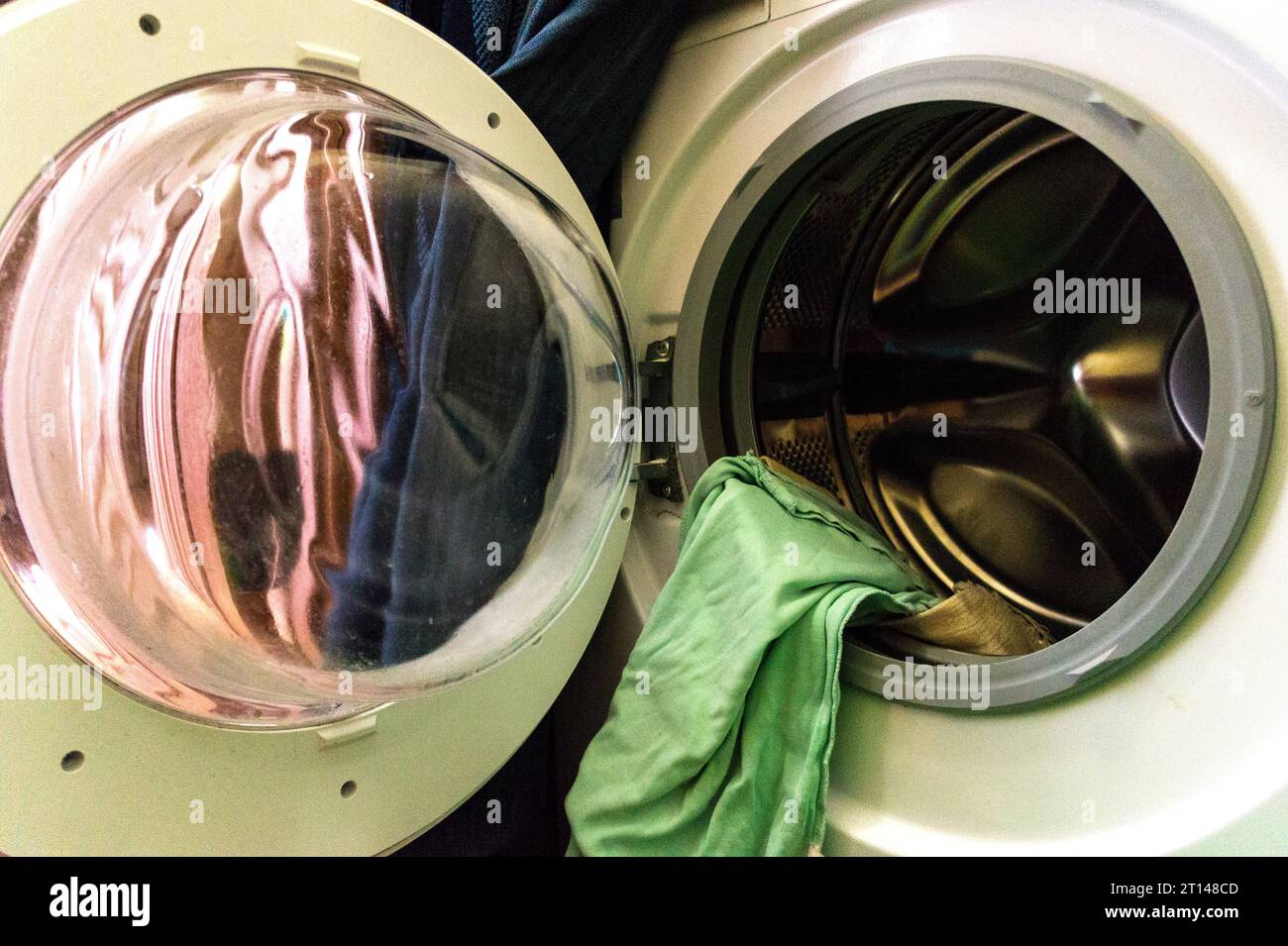 washed linen with washing machine. Linen and clothes are taken from the ...