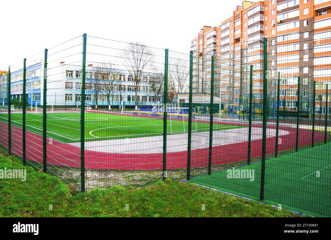 Football field with artificial lawn. Stadium and sports grounds near ...