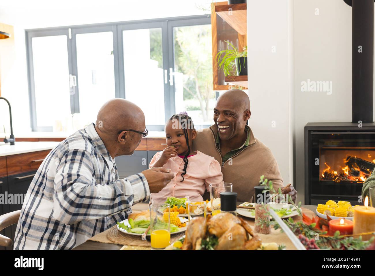 African american grandfather,father and daughter celebrating at ...