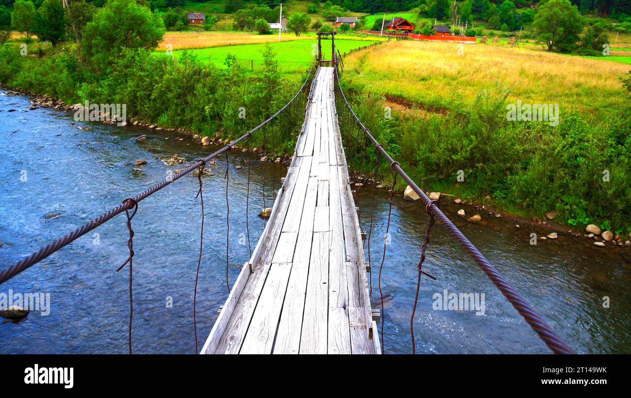 cable bridge,wooden bridge. Amazing wooden rope bridge over a river ...