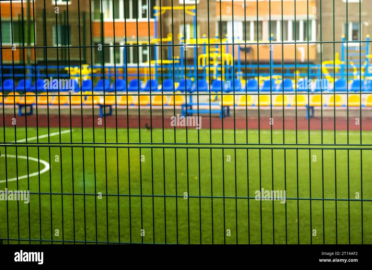 Football field with artificial lawn. Stadium and sports grounds near ...