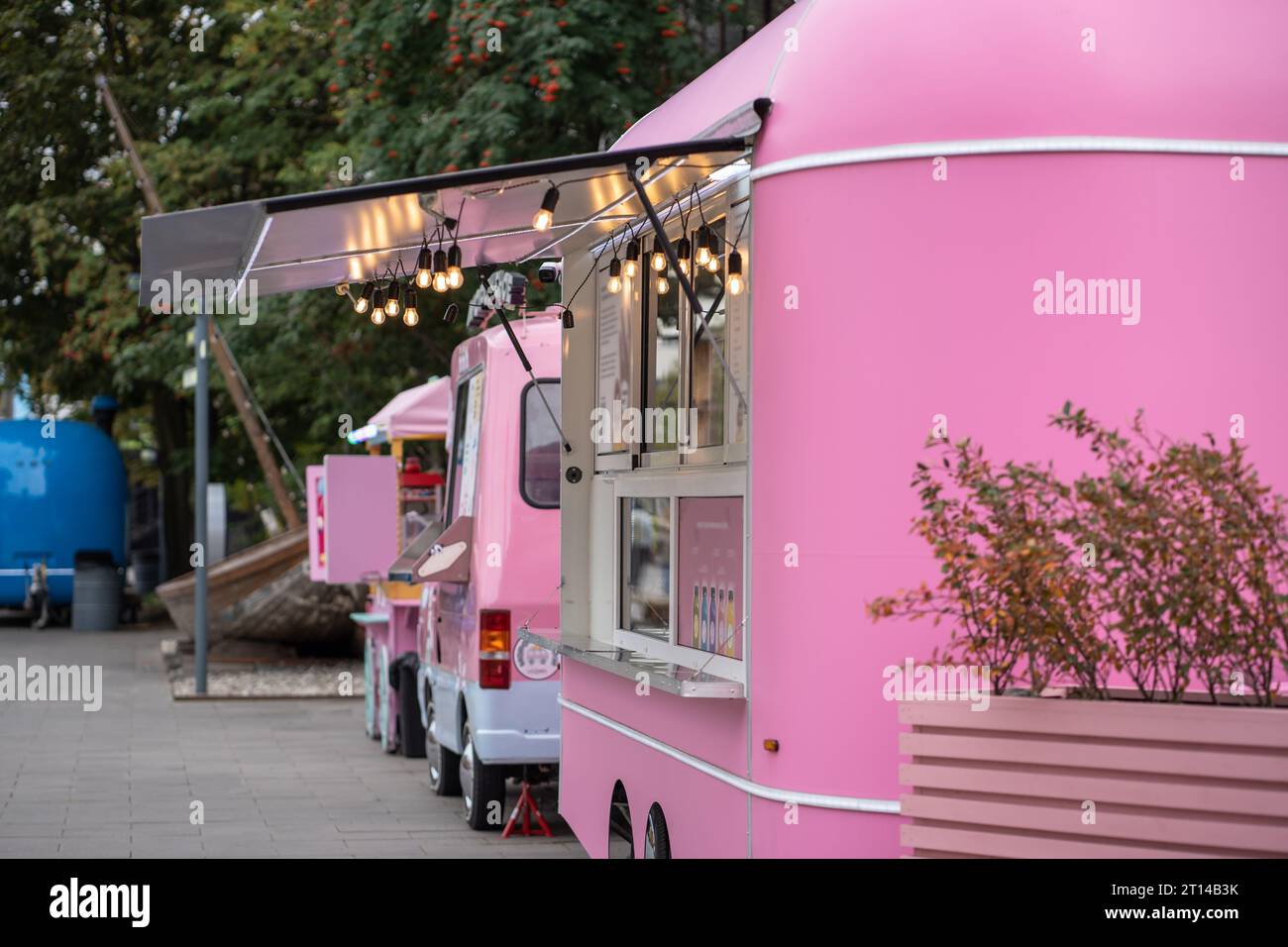 Pink ice cream vans on street in city, mobile fair trade with food ...