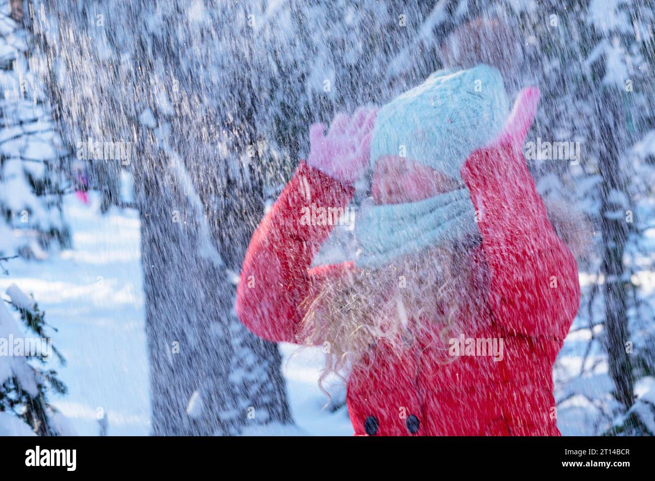 Blurred photo. Girl snowfall on the background of the forest. A child ...