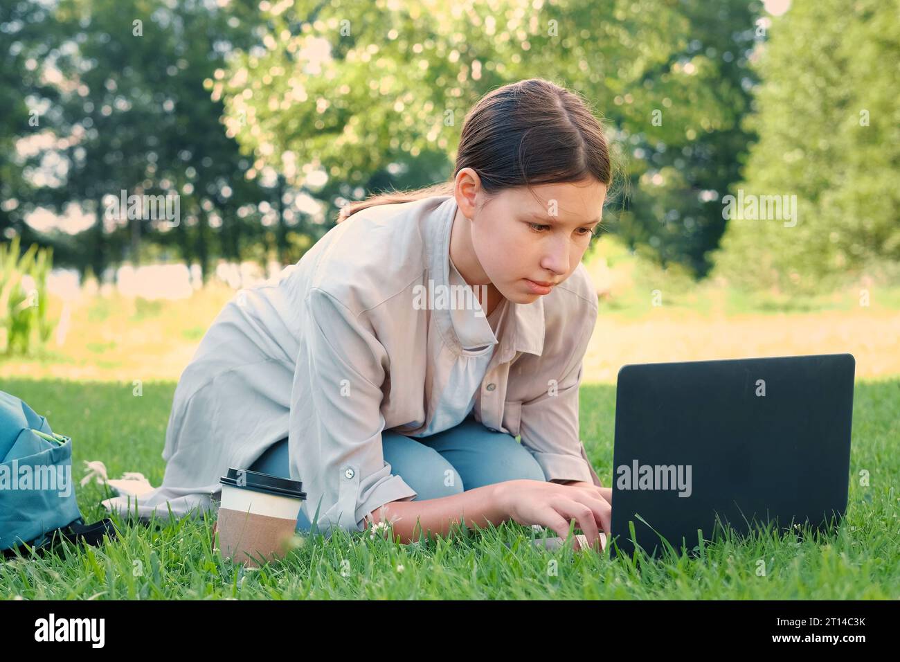 Teenage schoolgirl studying reading her books, tablet and notebook ...