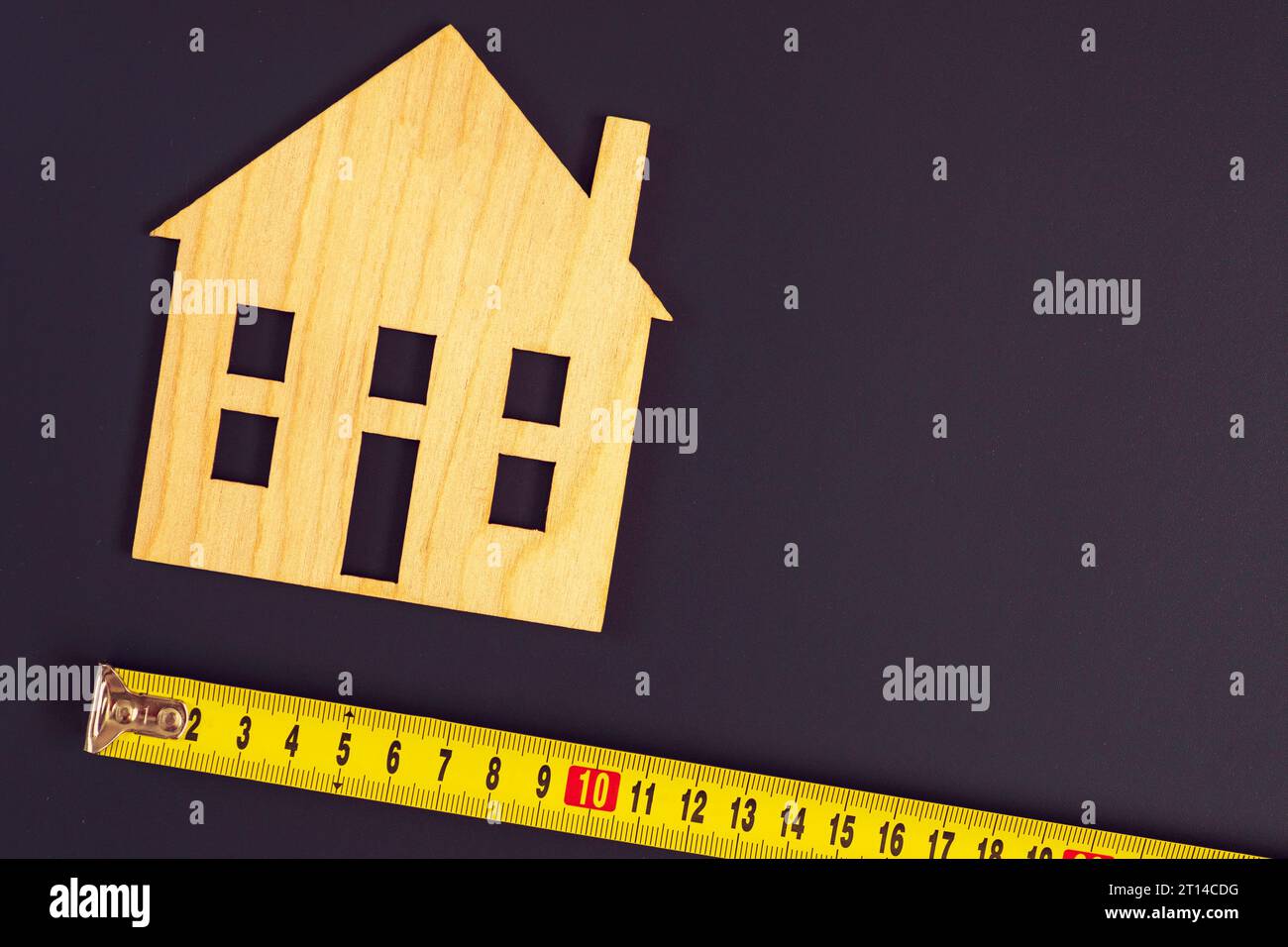 The image of the house on the background. Measurement of the size, tape ...