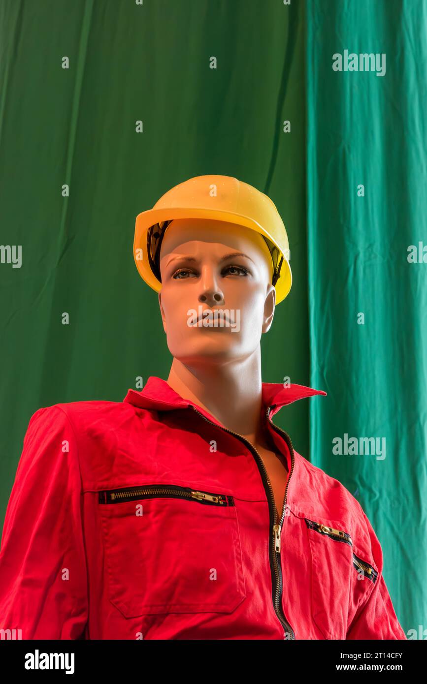 A doll dressed as a construction worker with helmet and overall Stock ...