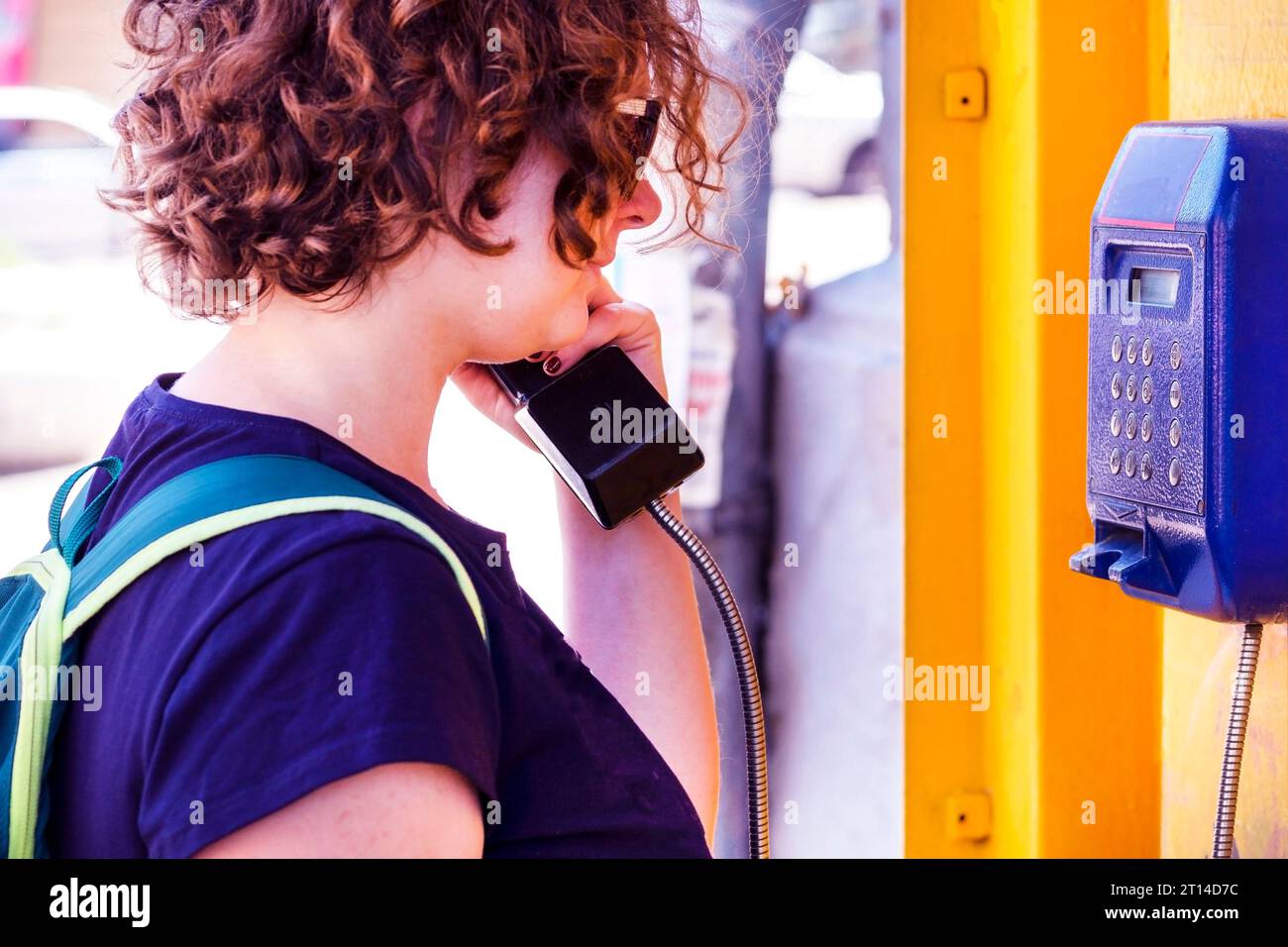 The girl holds a payphone tube. A call from the pay station. The ...