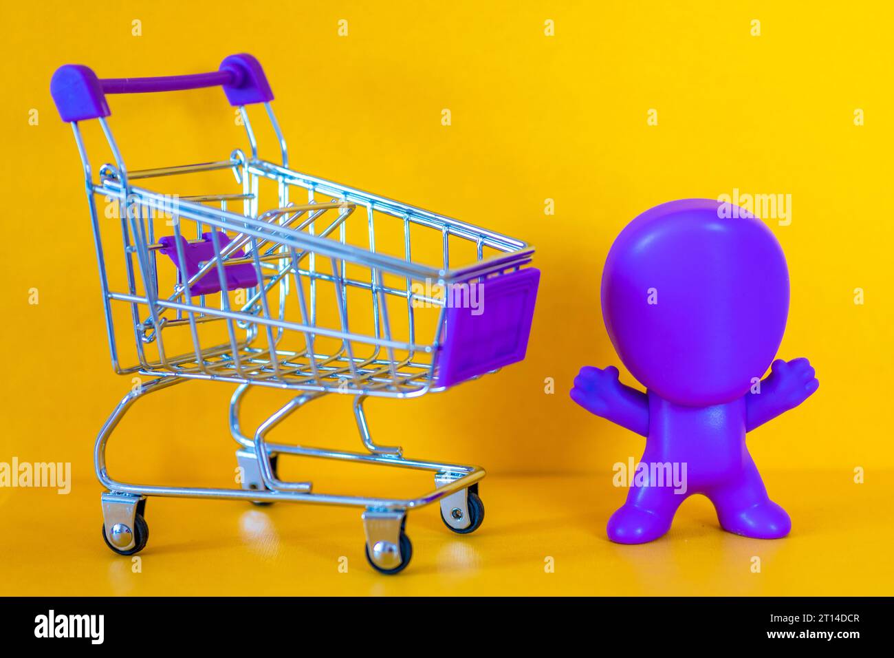 cart, hand-cart, shopping cart, trolley and human's figure on a yellow ...