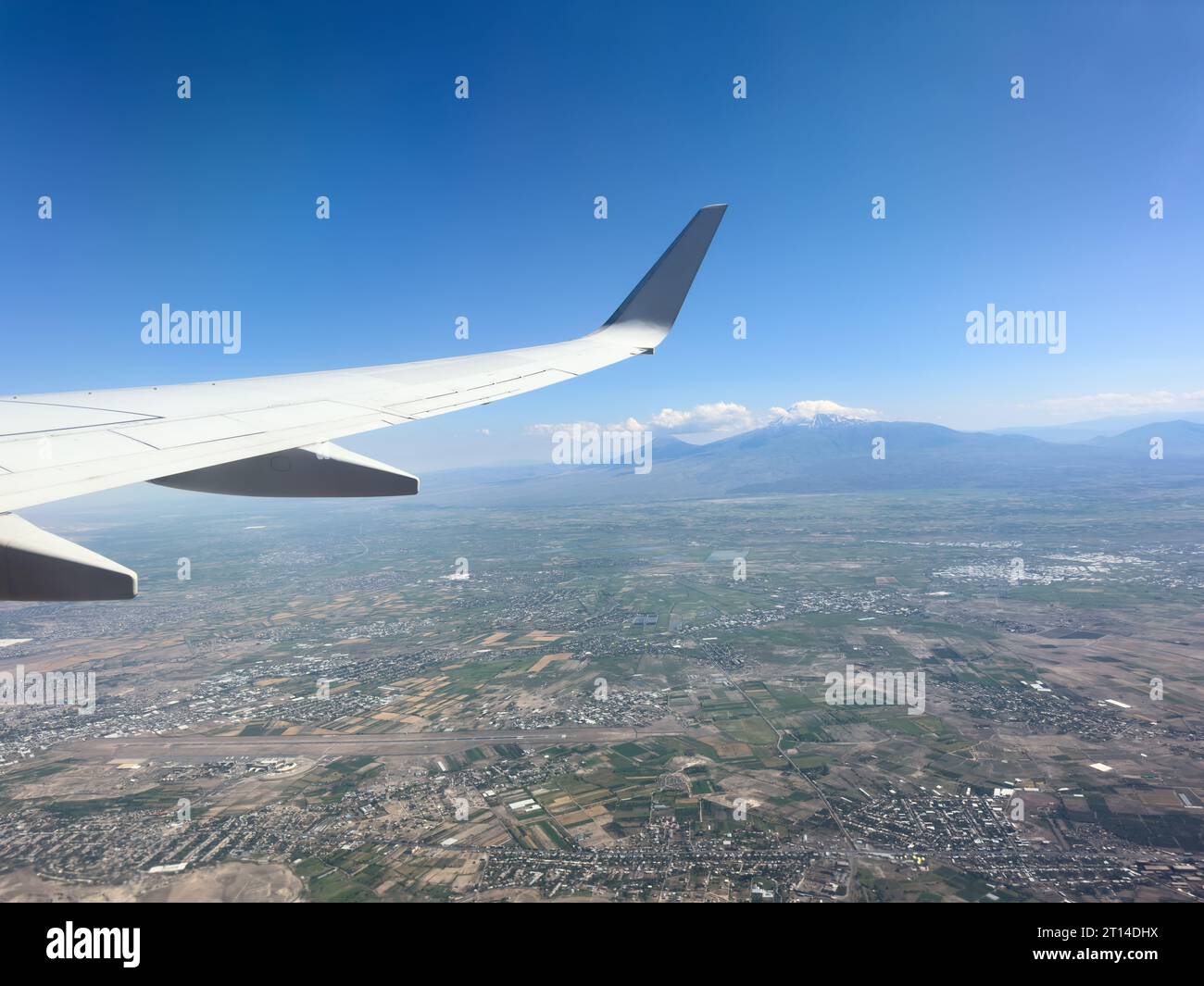White wing from airplane window over city. Great views of landscape ...