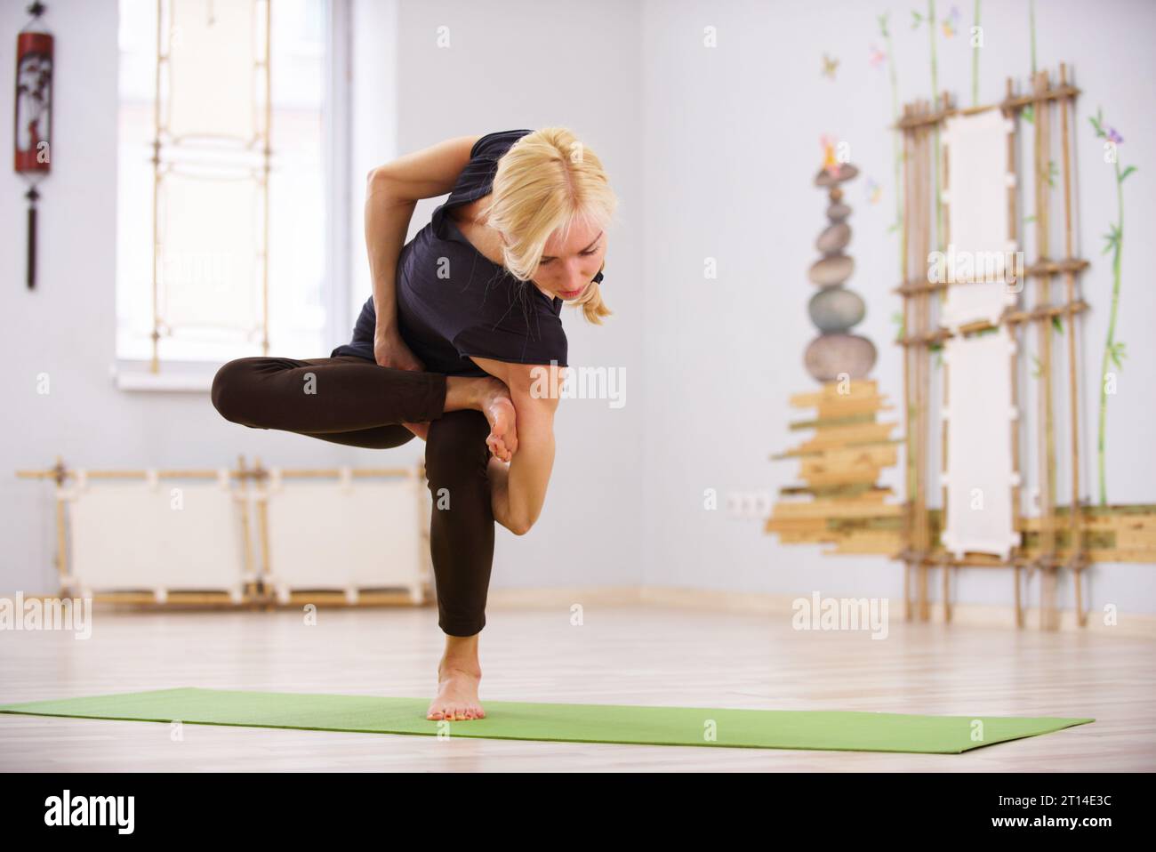 Beautiful sporty fit yogi woman practices yoga twist asana in the yoga ...