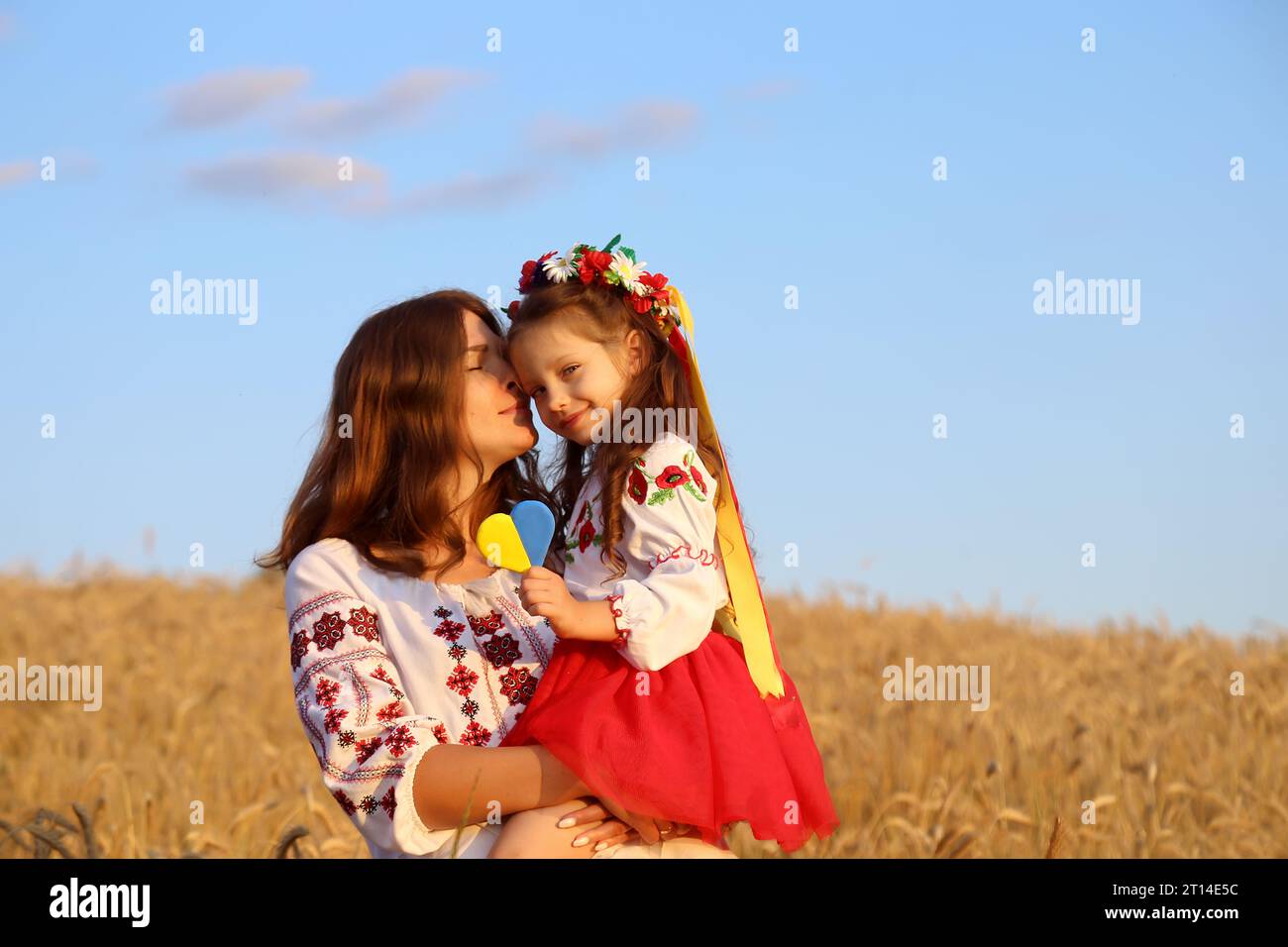 Happy smiling Ukrainian Mom and daughter in vyshyvanka (embroidered ...