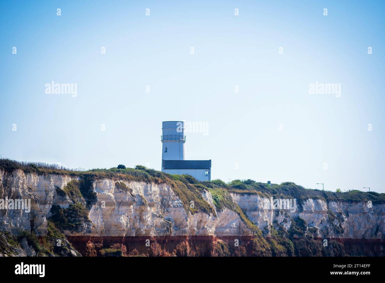 Lighthouse on colourful sandstone cliffs on british beach in england uk ...
