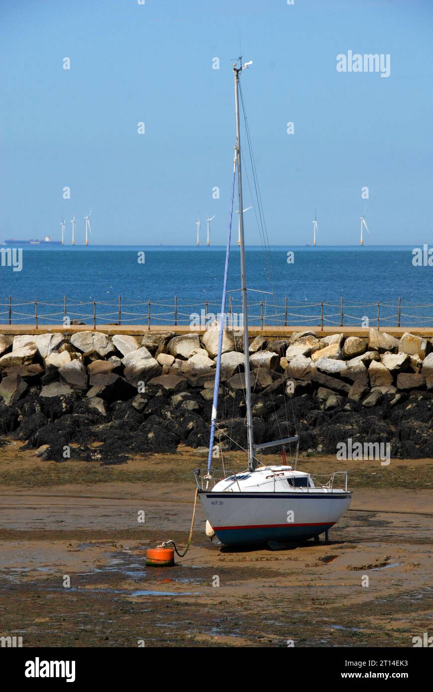 Sailing yacht awaiting the tide,Herne Bay, Kent with wind turbines ...