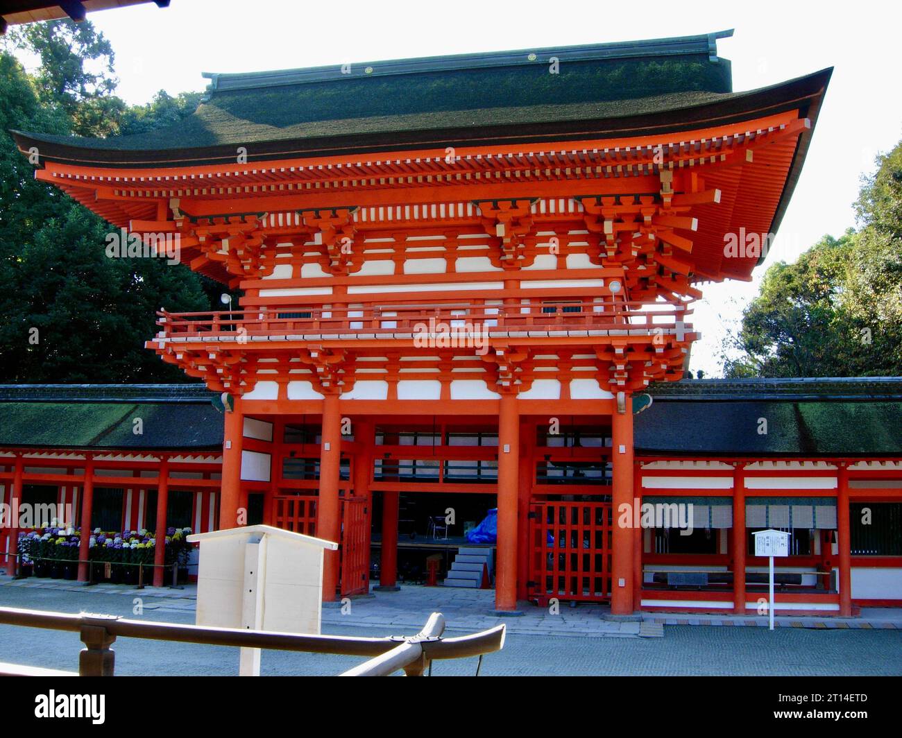 A bright red, Asian-style entrance to a building, featuring a majestic ...
