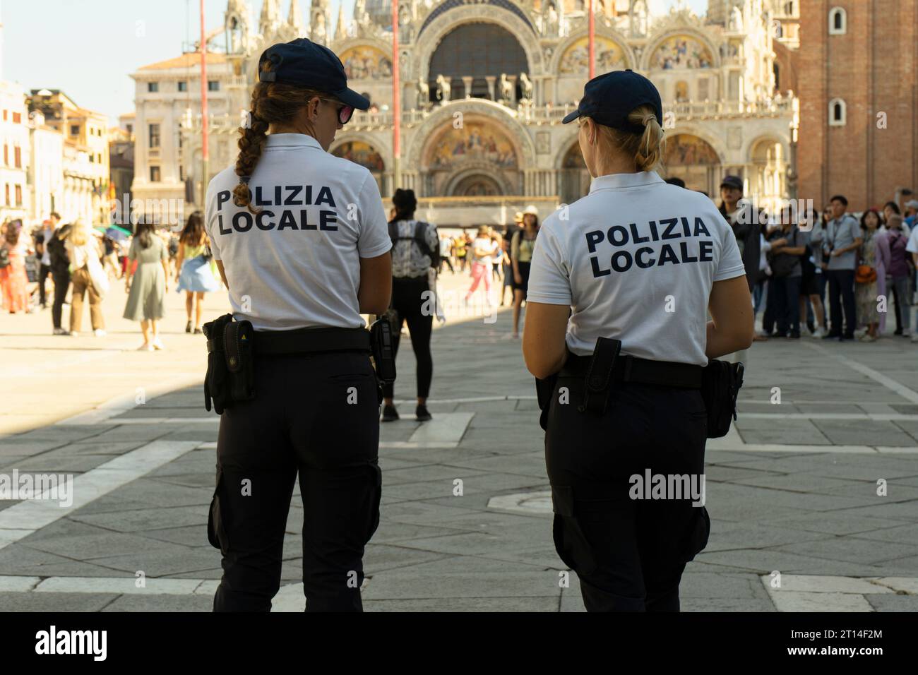 Rear view shot of two local police officers on duty for the safety of ...