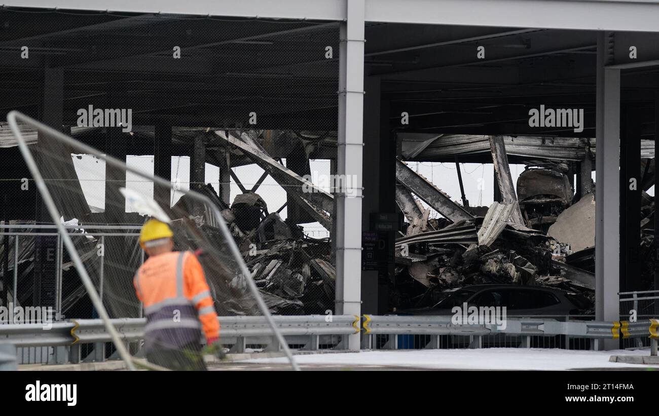 The burnt out shells of cars, buried amongst debris of a multi-storey ...