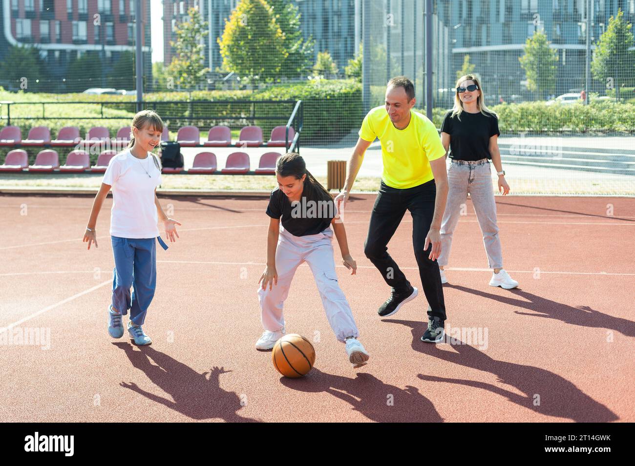family playing basketball on court Stock Photo - Alamy