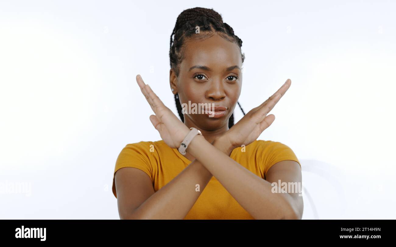 Portrait, woman and cross sign for stop, no and protest in studio for ...