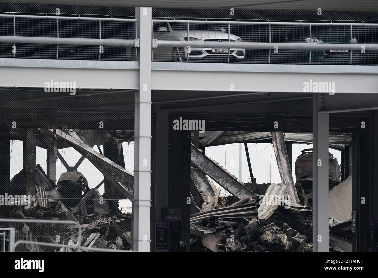 The burnt out shells of cars, buried amongst debris of a multi-storey ...