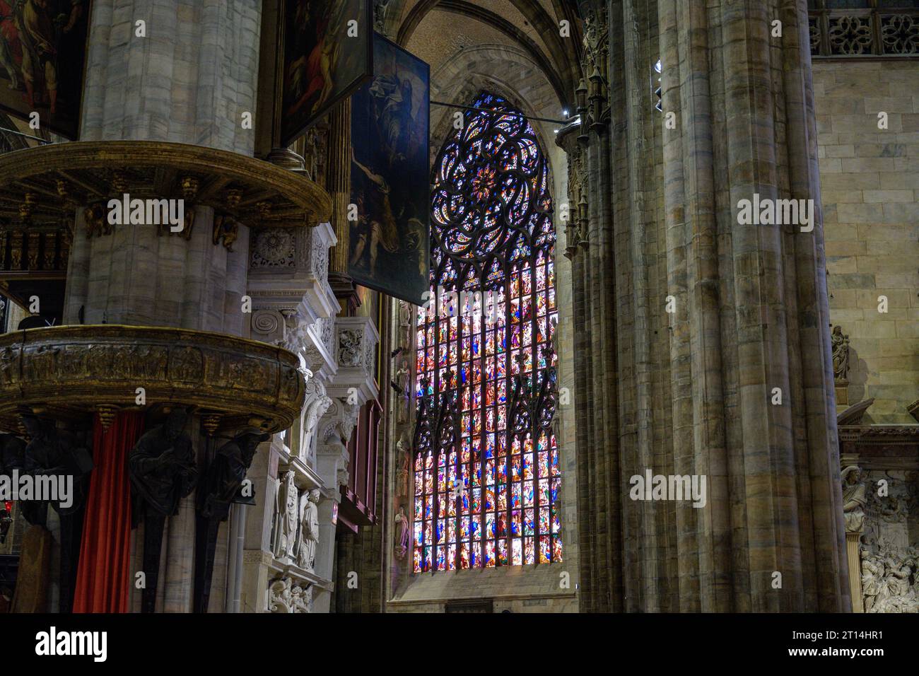 Large stain glass window between large stone columns within the Milan ...