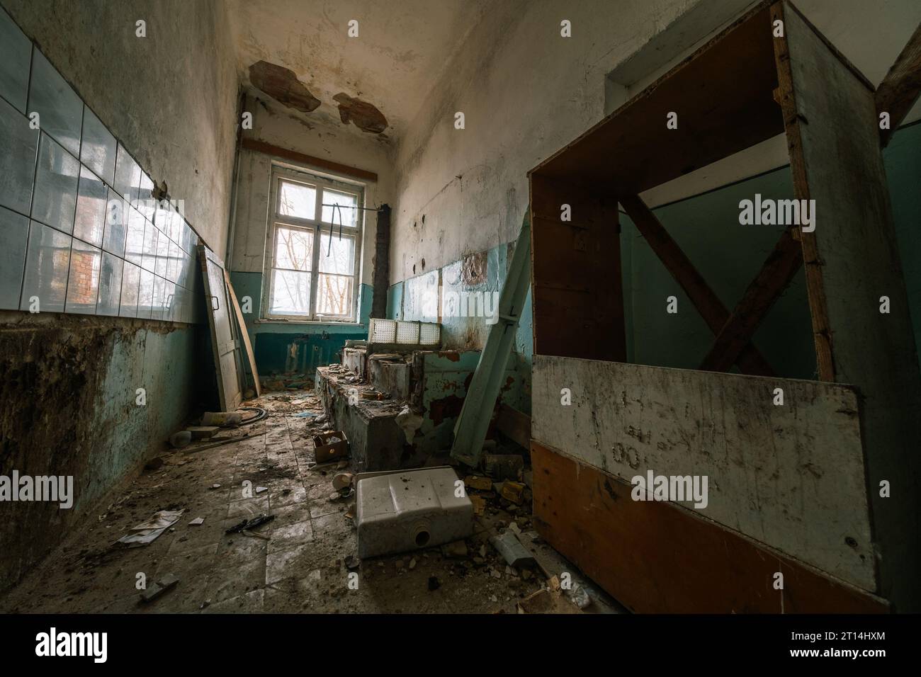 Interior of grungy room with weathered concrete steps and broken tiles ...