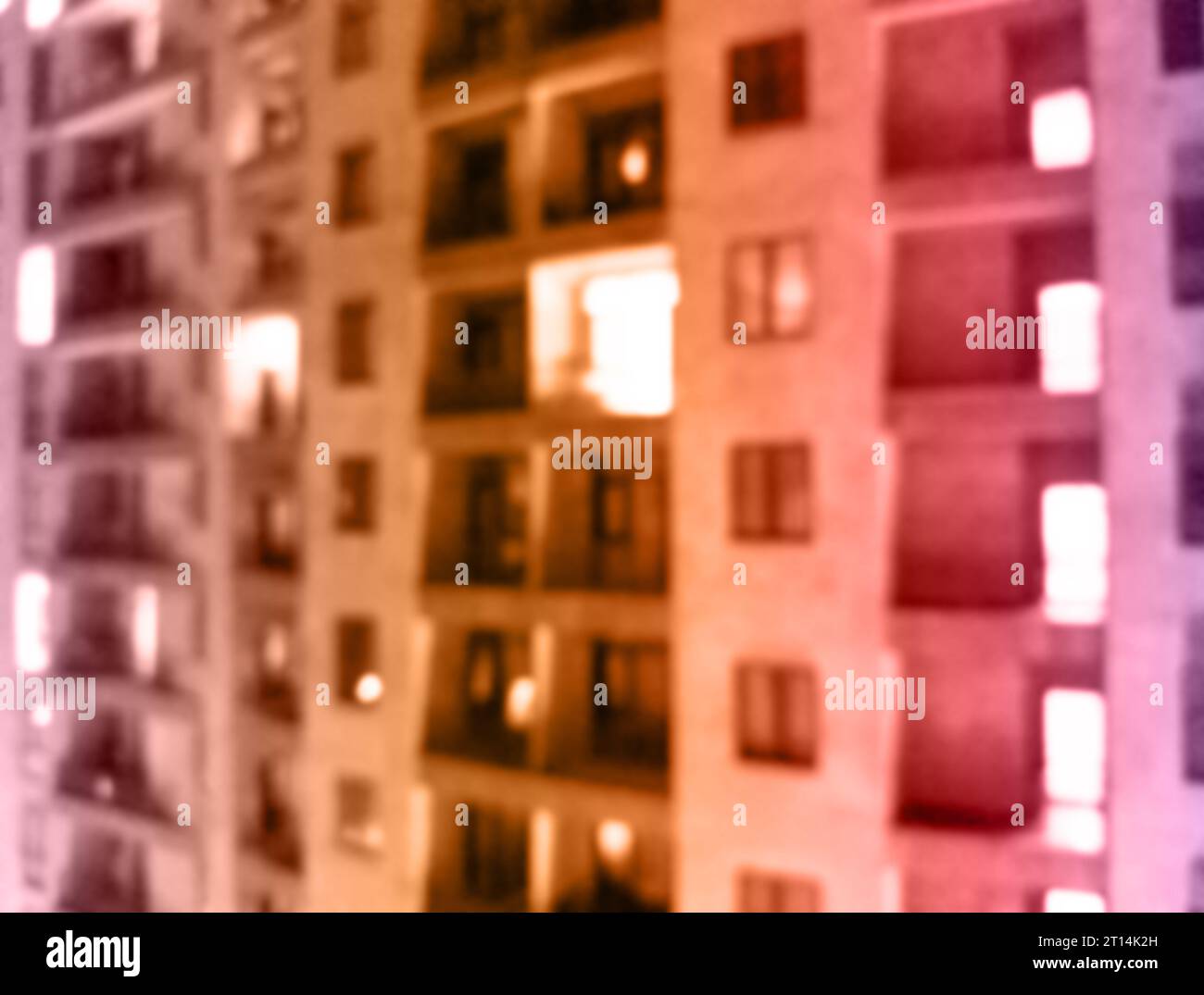 lurred office building with illuminated facade exterior at night ...