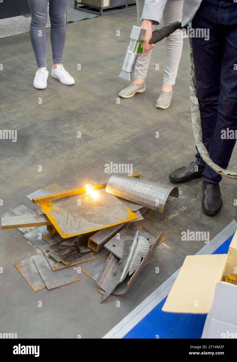 Laser metal cleaning. A man using laser metal cleaning machine to clean ...