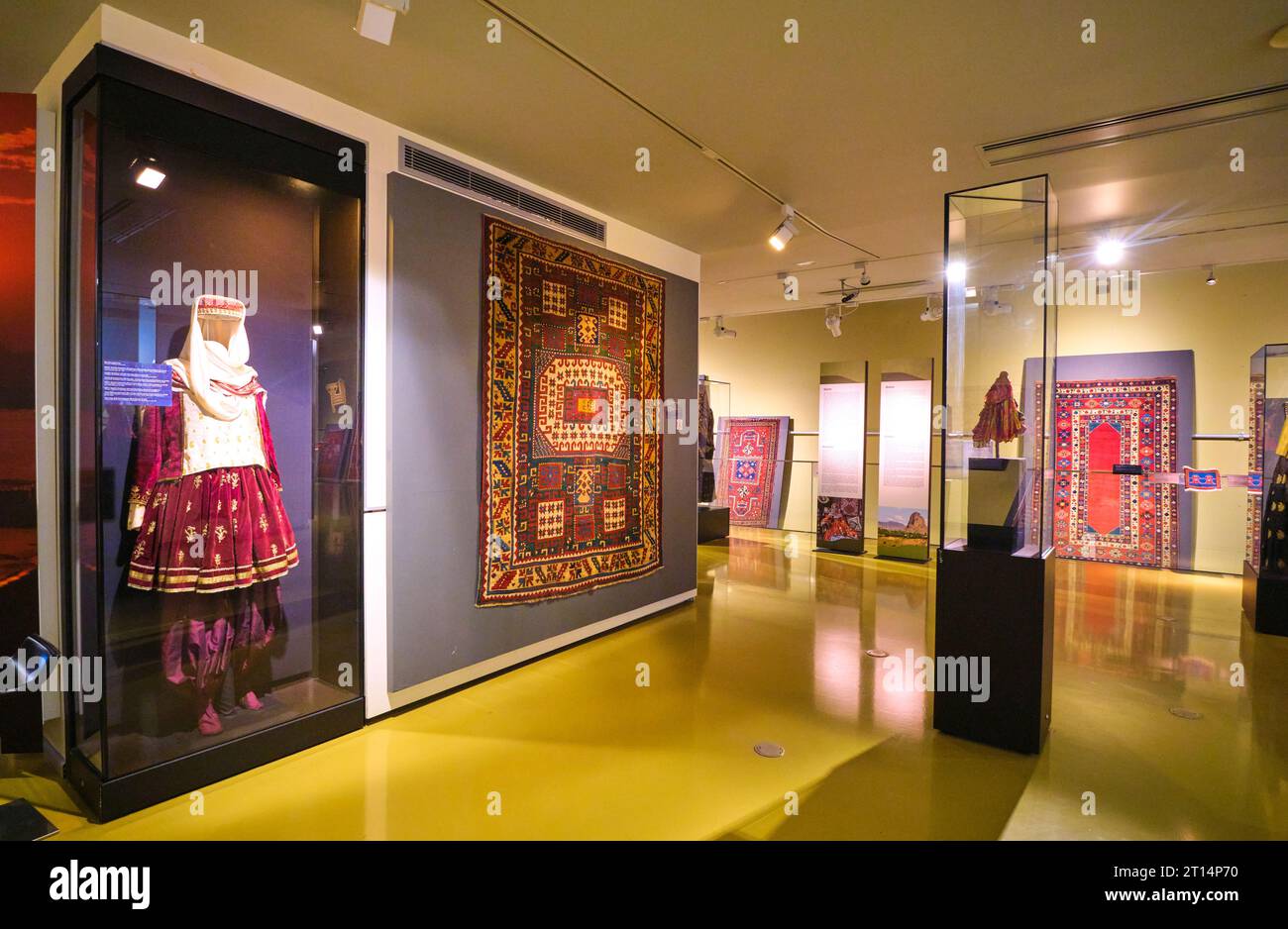Interior view in the display galleries of a mix of carpets, clothing ...