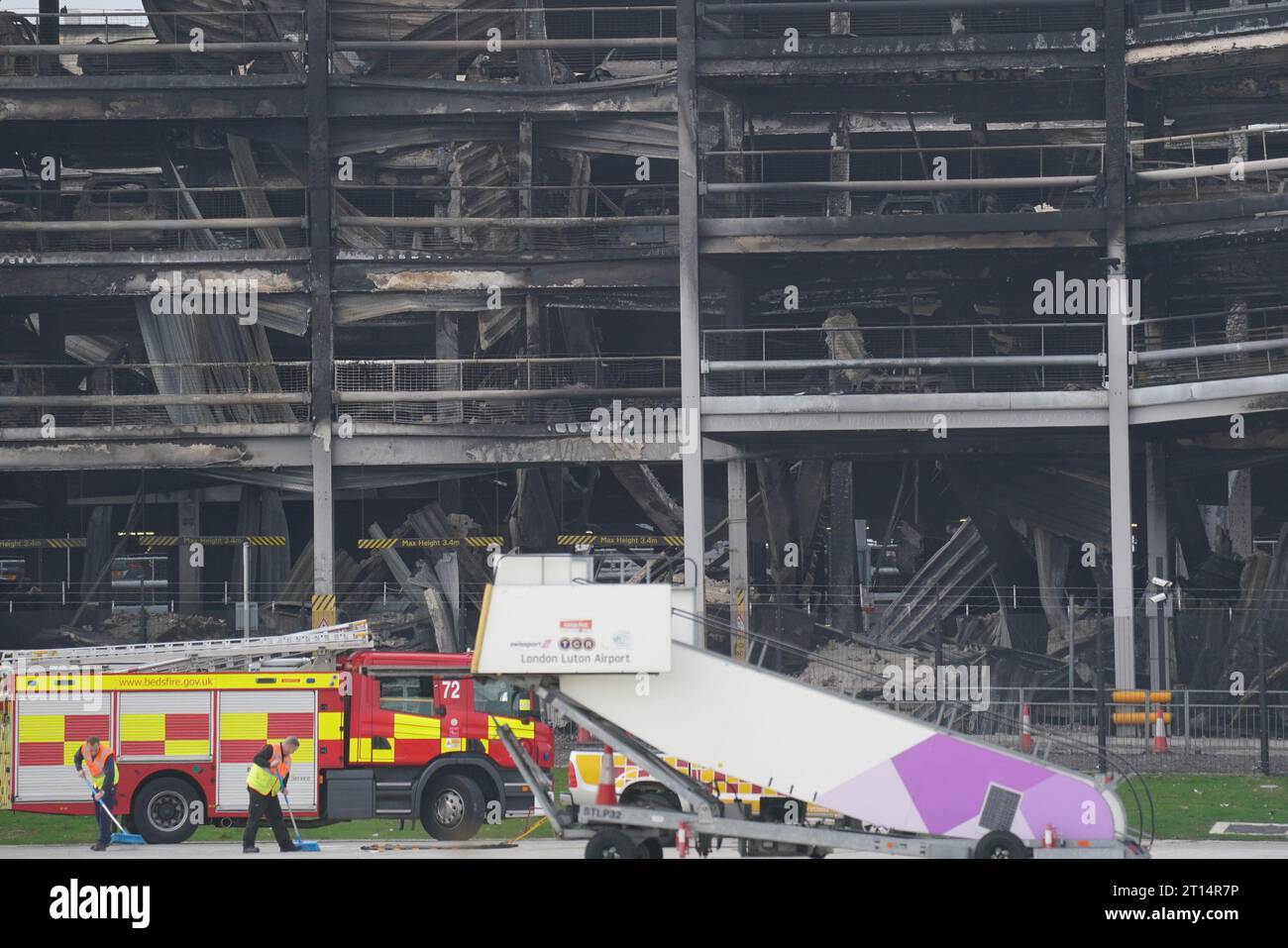 The burnt out shells of cars, buried amongst debris of a multi-storey ...