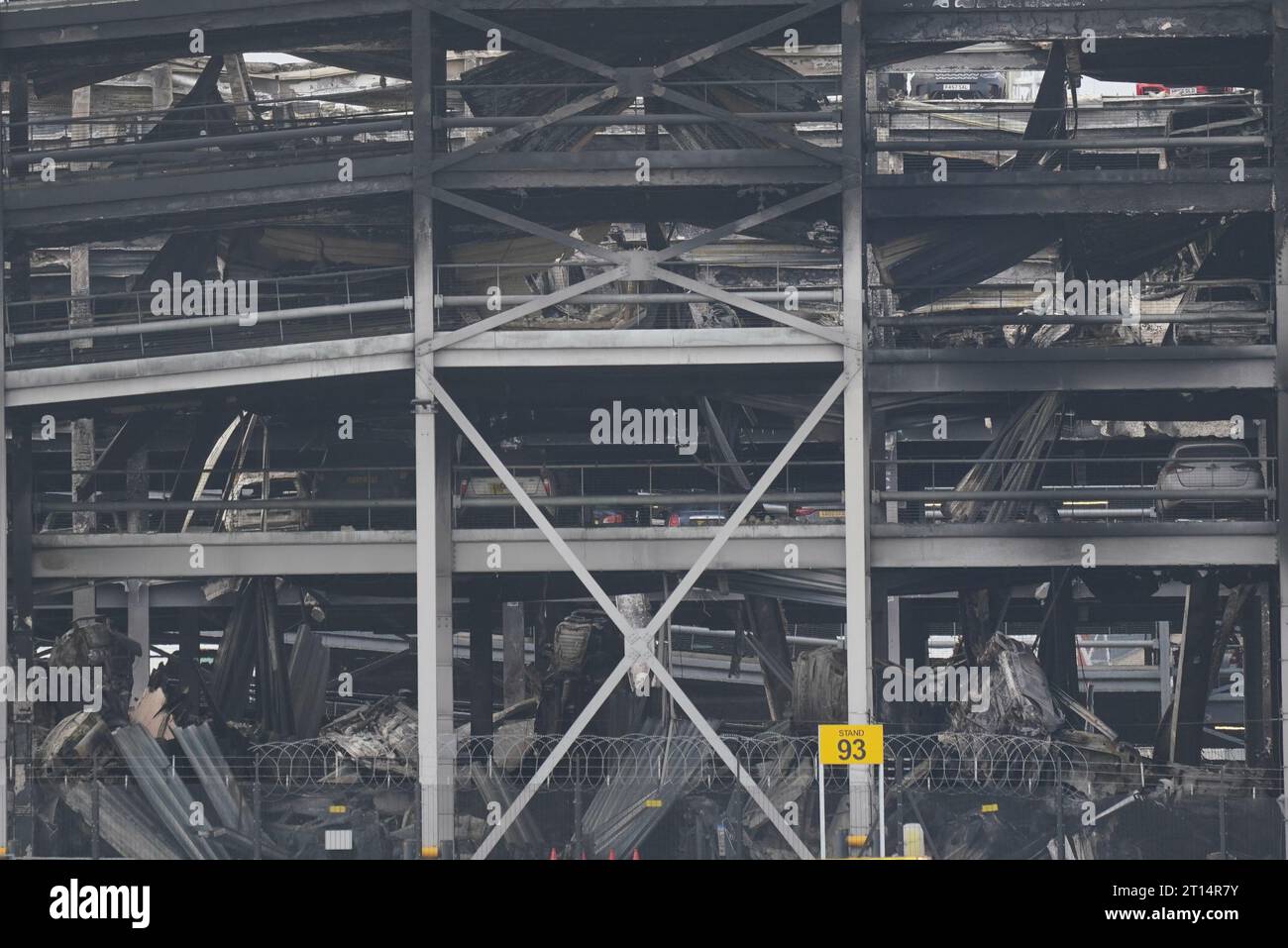 The burnt out shells of cars, buried amongst debris of a multi-storey ...